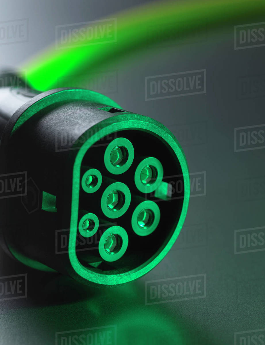 Studio shot of green electric car charging cable - Stock Photo - Dissolve