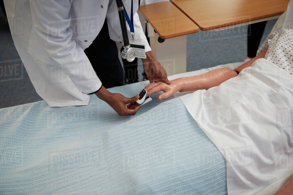 Medical student using pulse oximeter on dummy - Royalty-free Stock ...