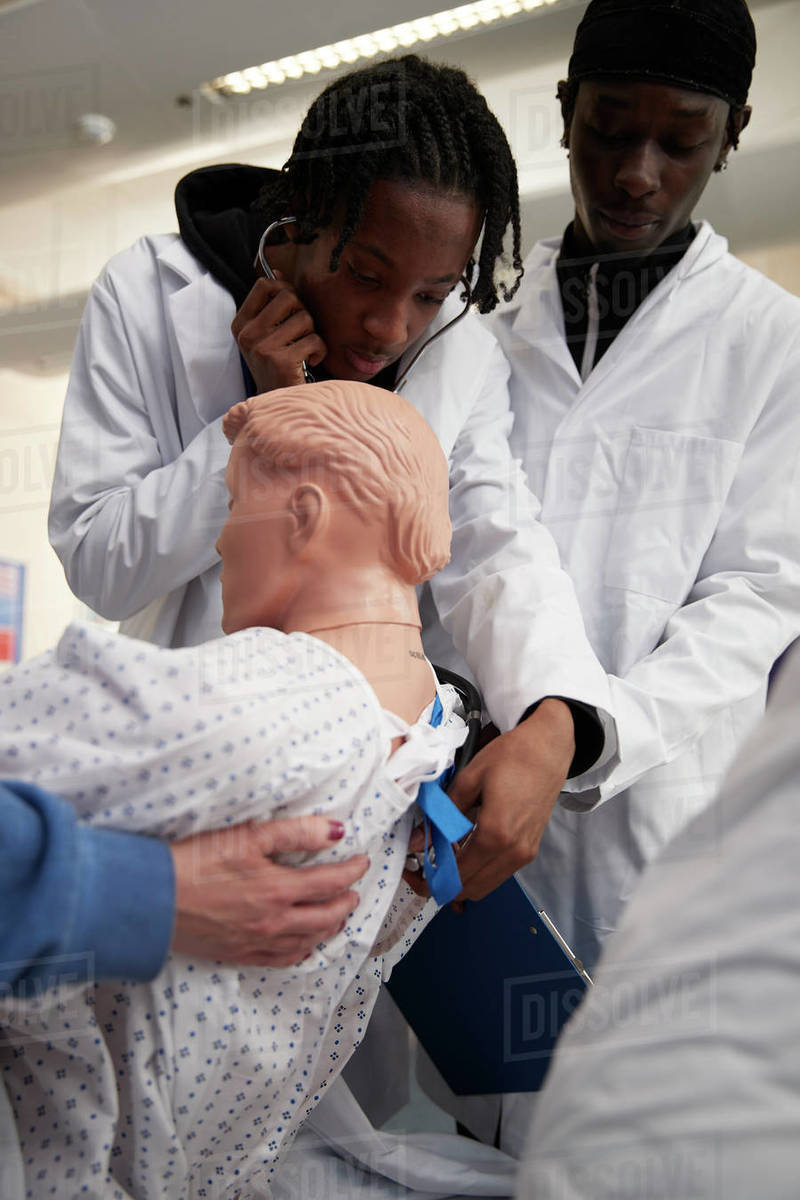 Medical students performing medical exam on dummy - Royalty-free Stock ...
