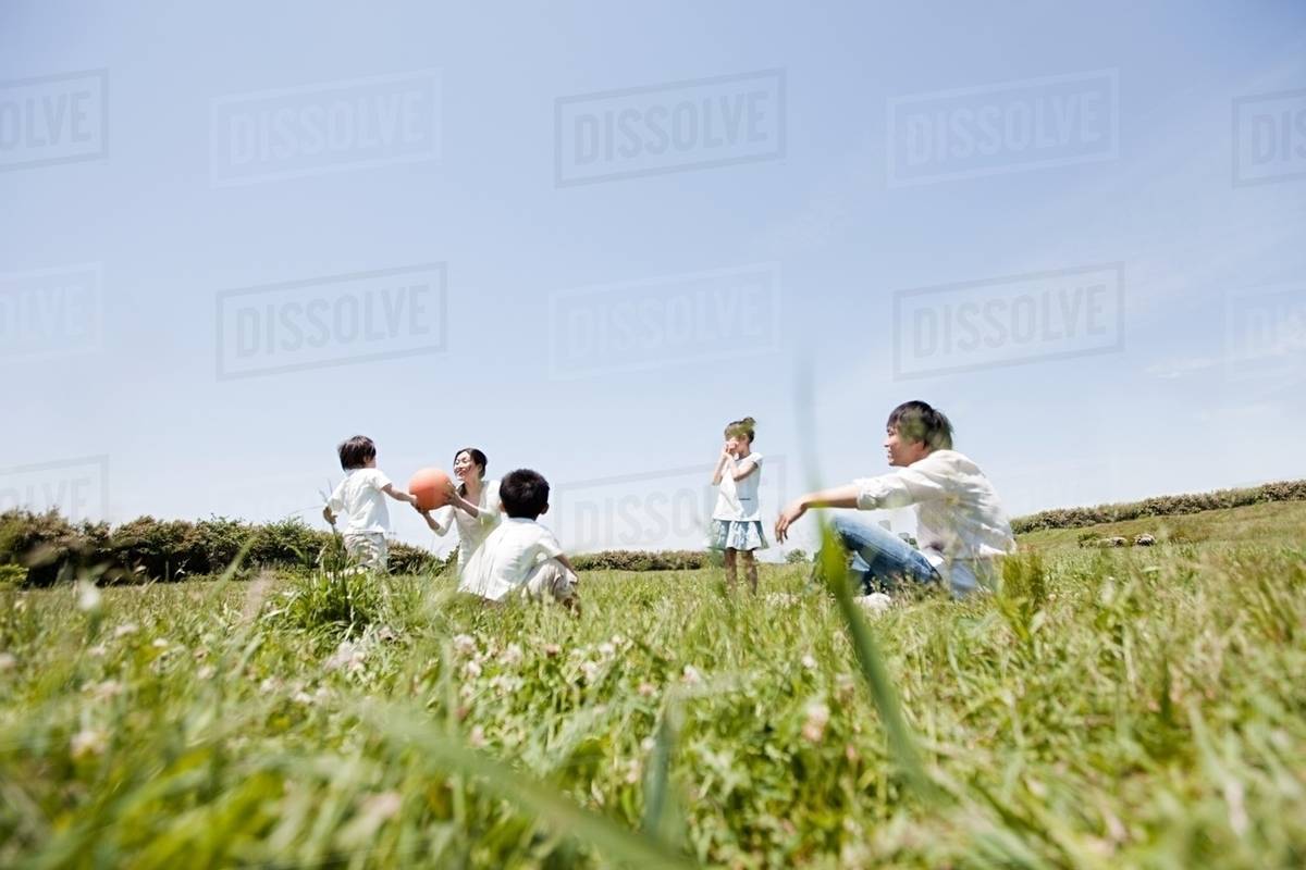 Family with three children in field - Royalty-free Stock Photo | Dissolve