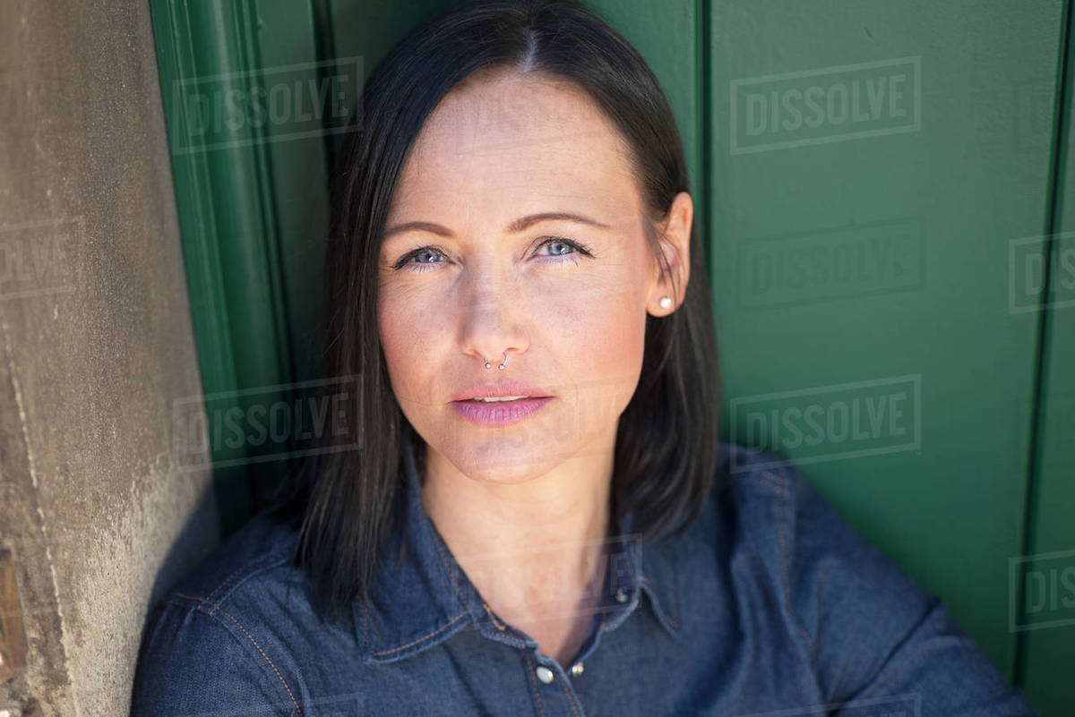 Germany, Portrait of serious woman outdoors - Stock Photo - Dissolve