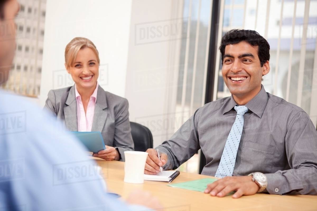 Business executives smiling in a meeting - Royalty-free Stock Photo ...