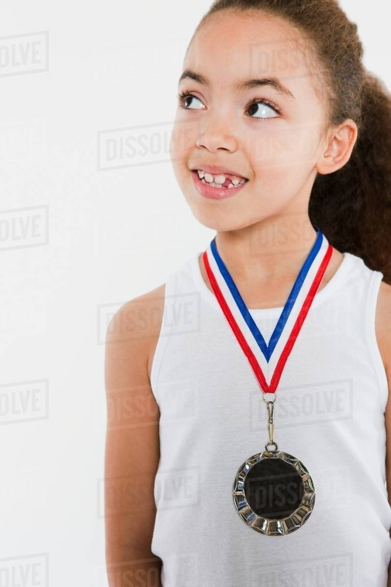 Girl wearing a medal - Royalty-free Stock Photo | Dissolve