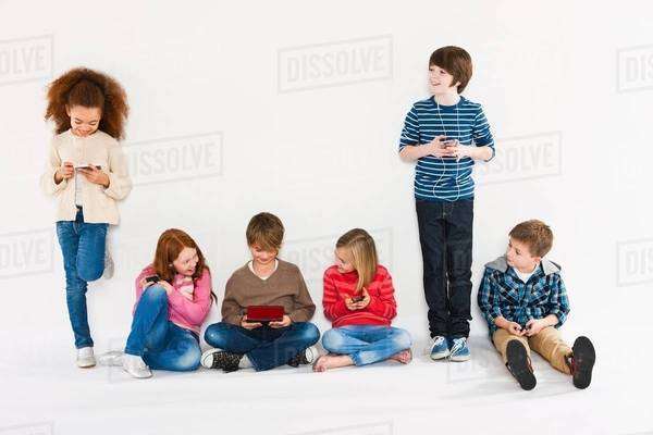 Children using different gadgets - Stock Photo - Dissolve