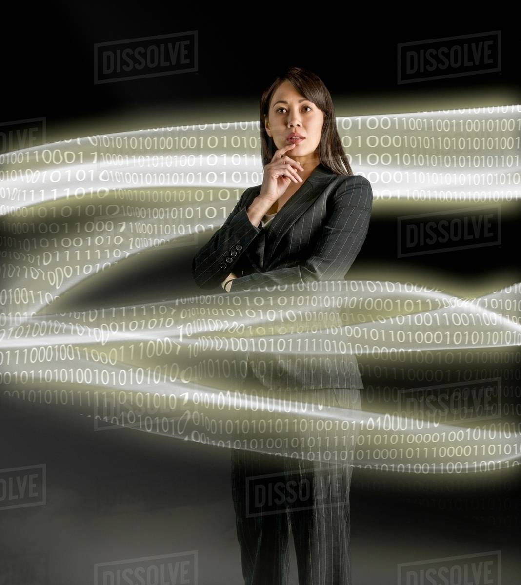 Businesswoman looking at data streams - Royalty-free Stock Photo | Dissolve