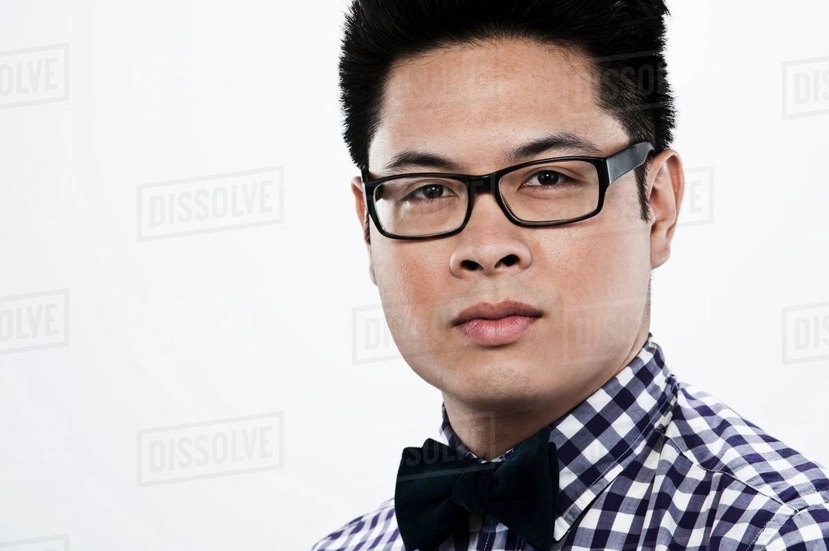 Portrait of young man against white background - Stock Photo - Dissolve
