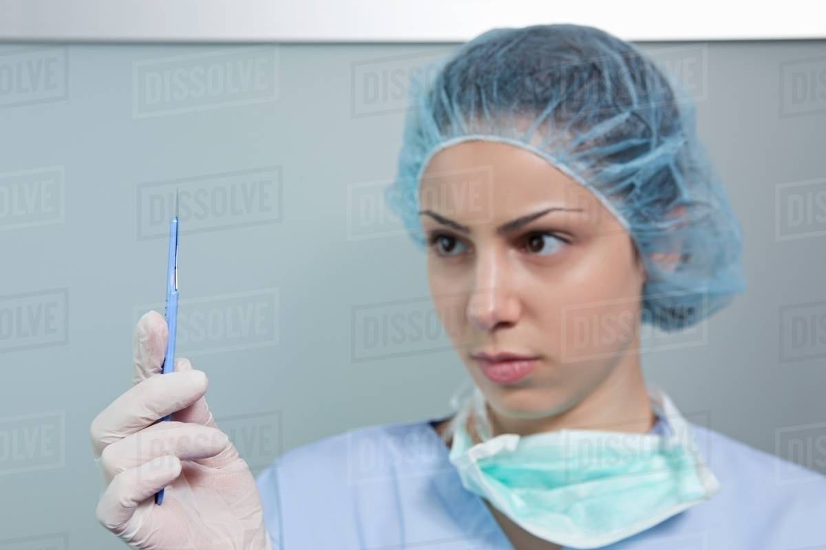Surgeon holding scalpel - Royalty-free Stock Photo | Dissolve