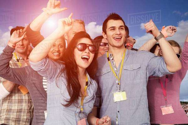 People cheering at a music festival - Royalty-free Stock Photo | Dissolve