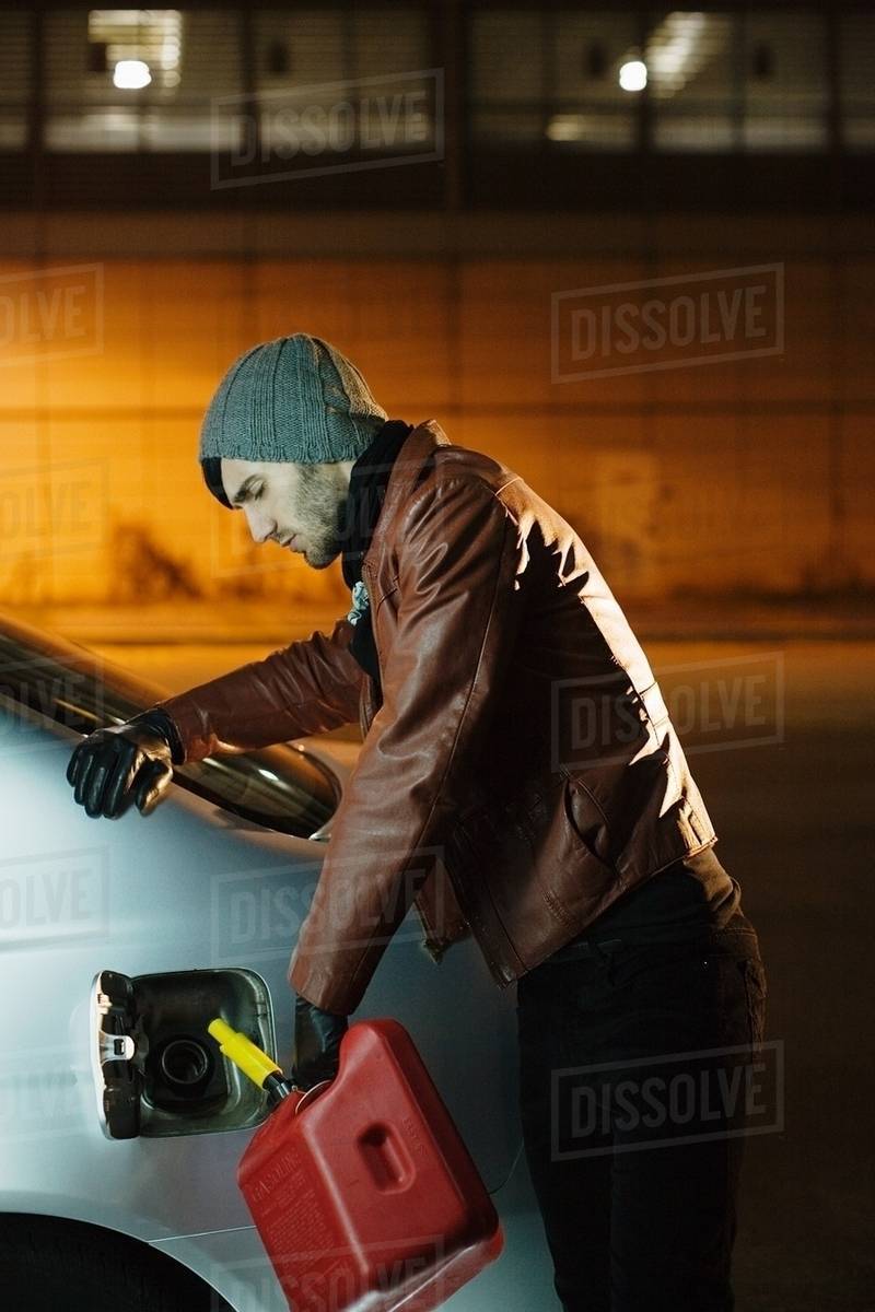 Man putting petrol in car - Stock Photo - Dissolve