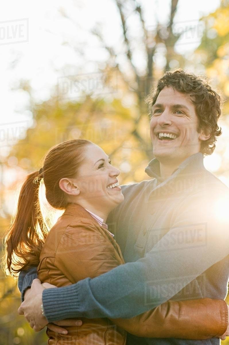 Couple hugging in park - Royalty-free Stock Photo | Dissolve