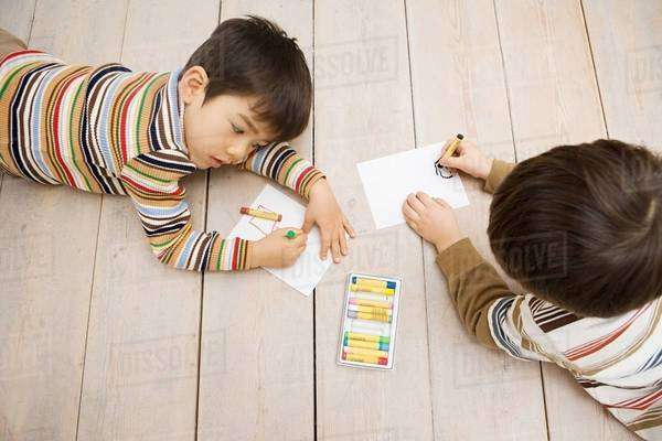 Boys drawing with crayons - Royalty-free Stock Photo | Dissolve