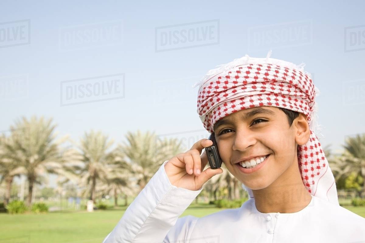 A boy using a cell phone - Stock Photo - Dissolve