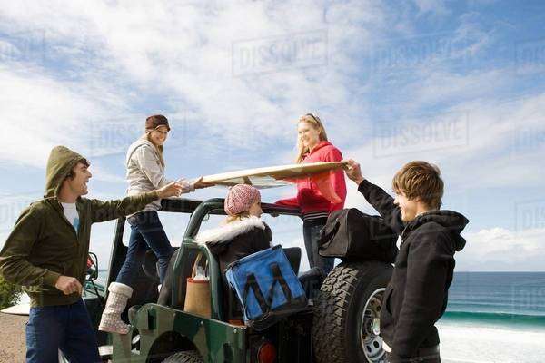 Surfer friends at the coast - Royalty-free Stock Photo | Dissolve