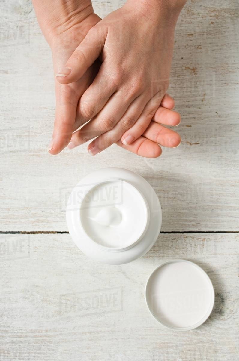 Woman using hand cream - Royalty-free Stock Photo | Dissolve