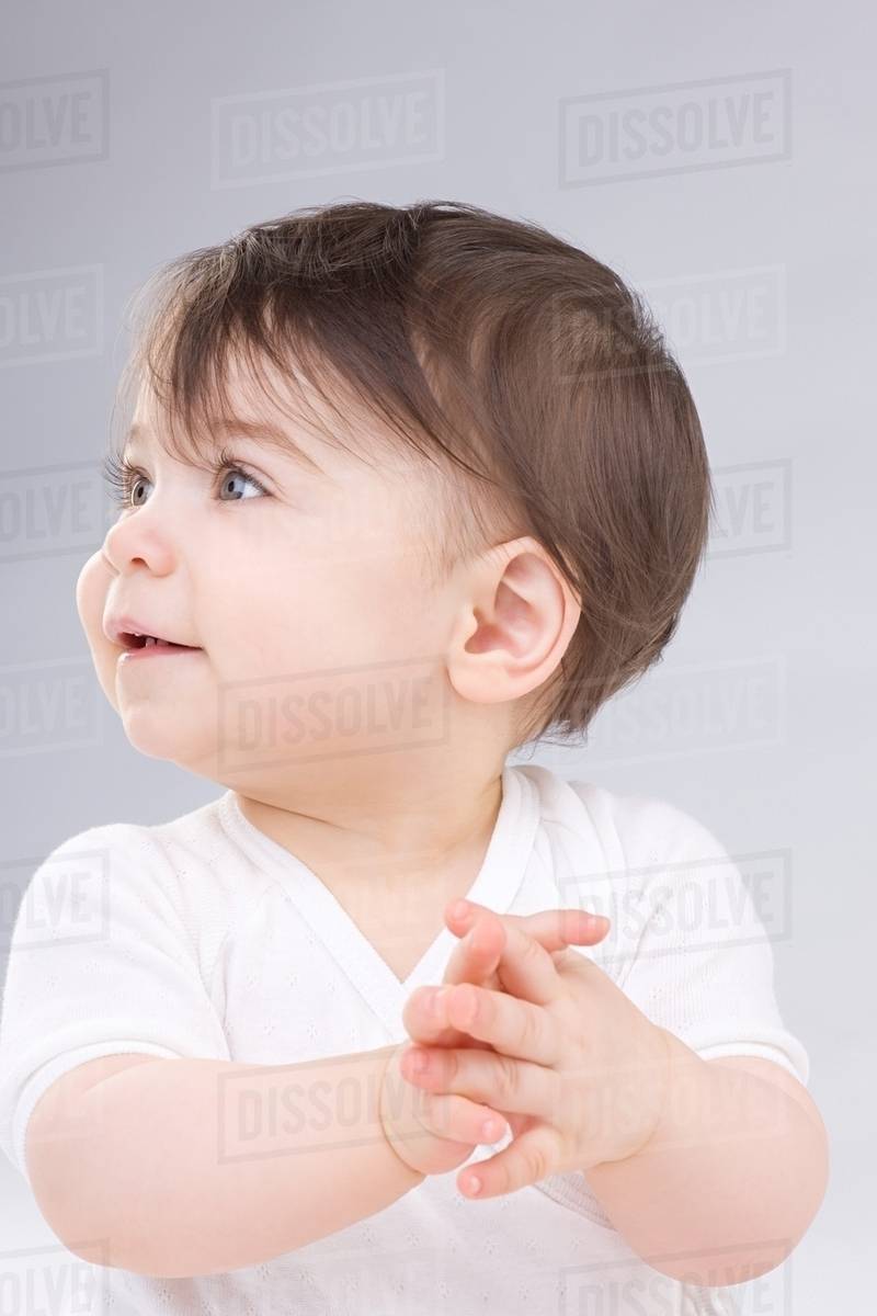 Baby girl with hands together - Royalty-free Stock Photo | Dissolve