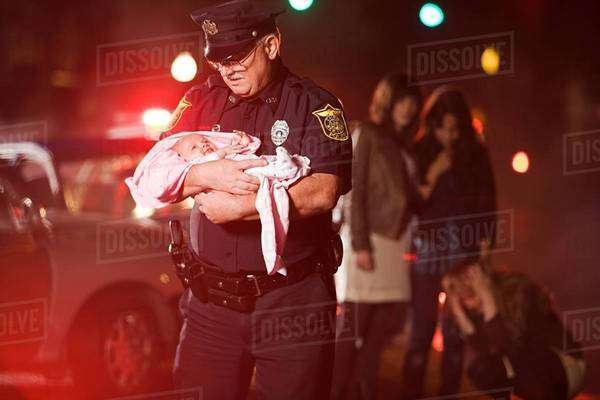 Police officer rescuing a baby - Royalty-free Stock Photo | Dissolve