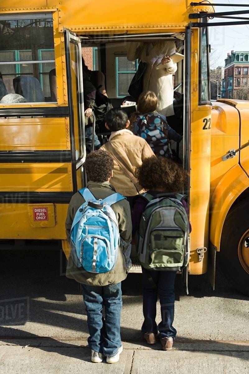 Children boarding school bus - Royalty-free Stock Photo | Dissolve