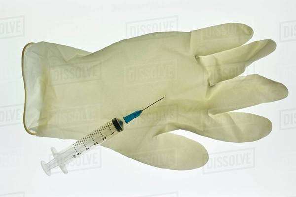 Syringe and surgical glove - Stock Photo - Dissolve