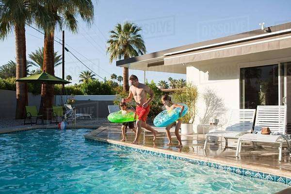 Family and outdoor swimming pool - Royalty-free Stock Photo | Dissolve
