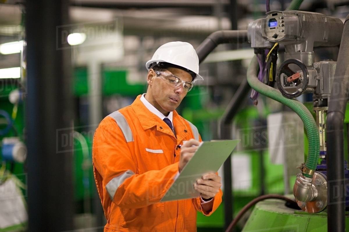 Engineer in factory with clipboard - Royalty-free Stock Photo | Dissolve