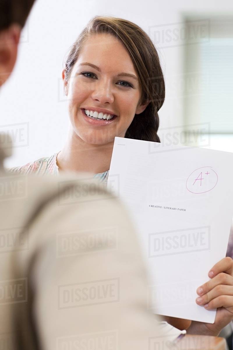 Successful female high school student holding assignment - Stock Photo ...