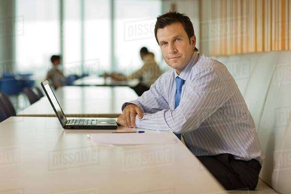 Businessman with laptop - Stock Photo - Dissolve