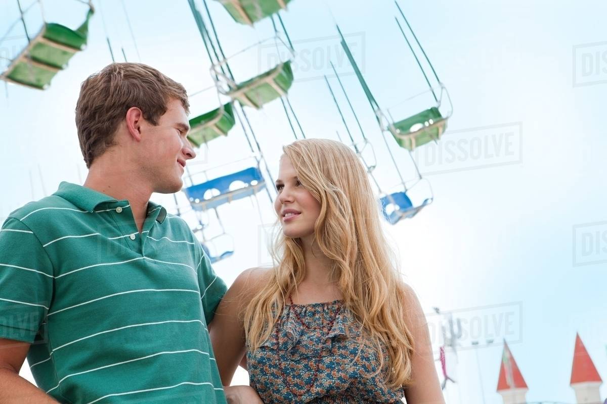 Teenage couple at fun fair - Royalty-free Stock Photo | Dissolve