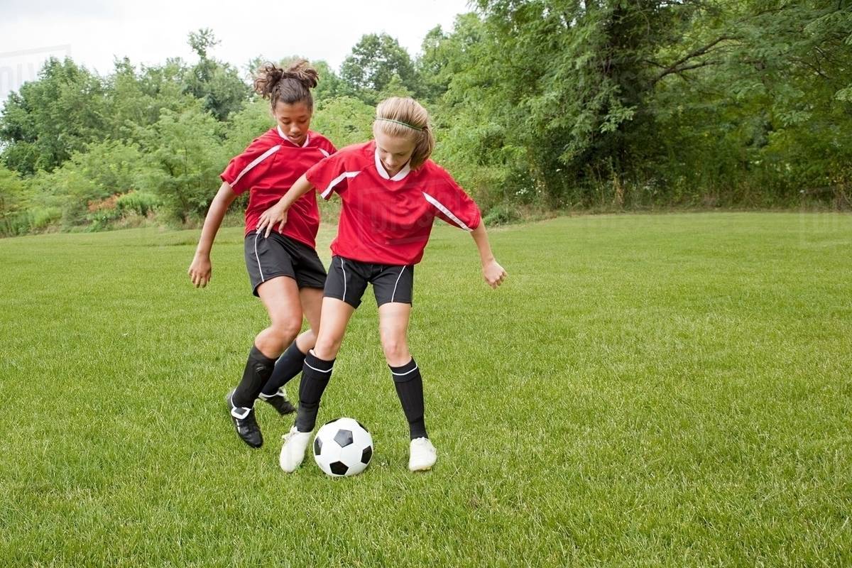 Girls playing soccer - Stock Photo - Dissolve