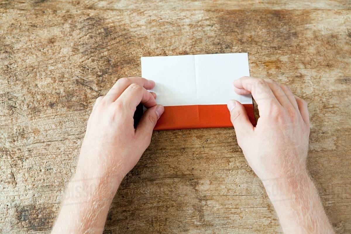 Person folding paper - Royalty-free Stock Photo | Dissolve