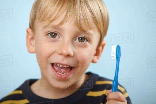 Boy holding toothbrush - Royalty-free Stock Photo | Dissolve