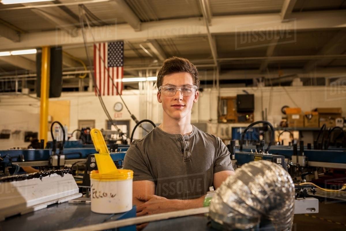 Worker operating machinery in factory - Stock Photo - Dissolve