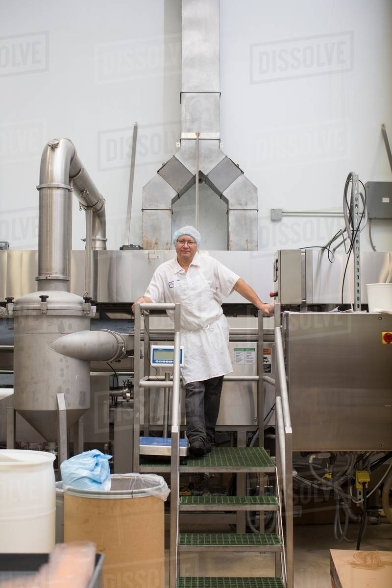 Man standing on steps in food production factory - Royalty-free Stock ...