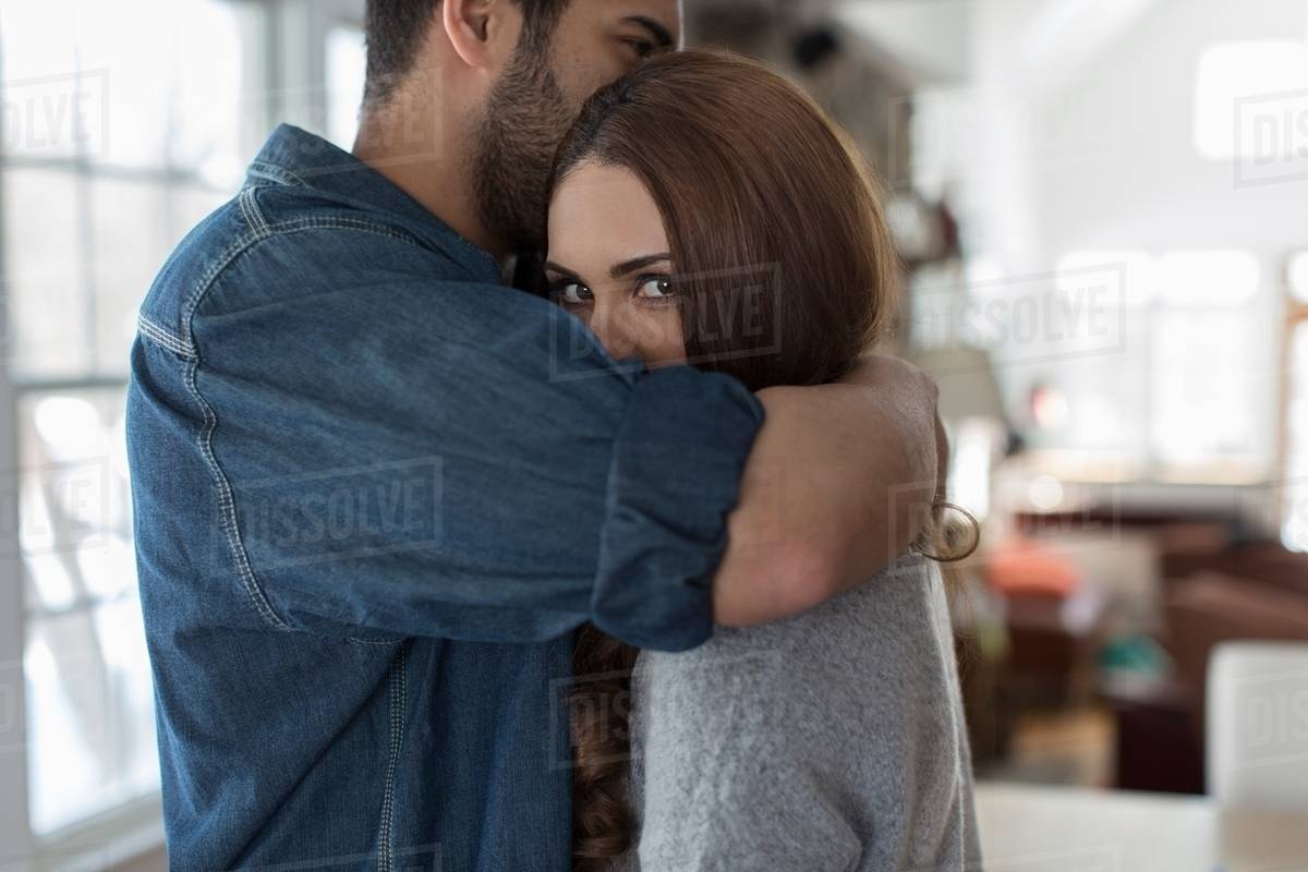 Young man hugging woman - Stock Photo - Dissolve