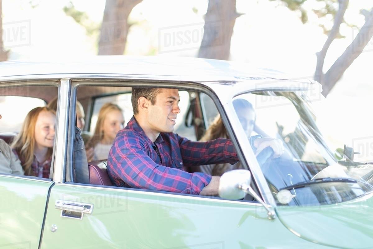 Family in car together, taking road trip - Stock Photo - Dissolve