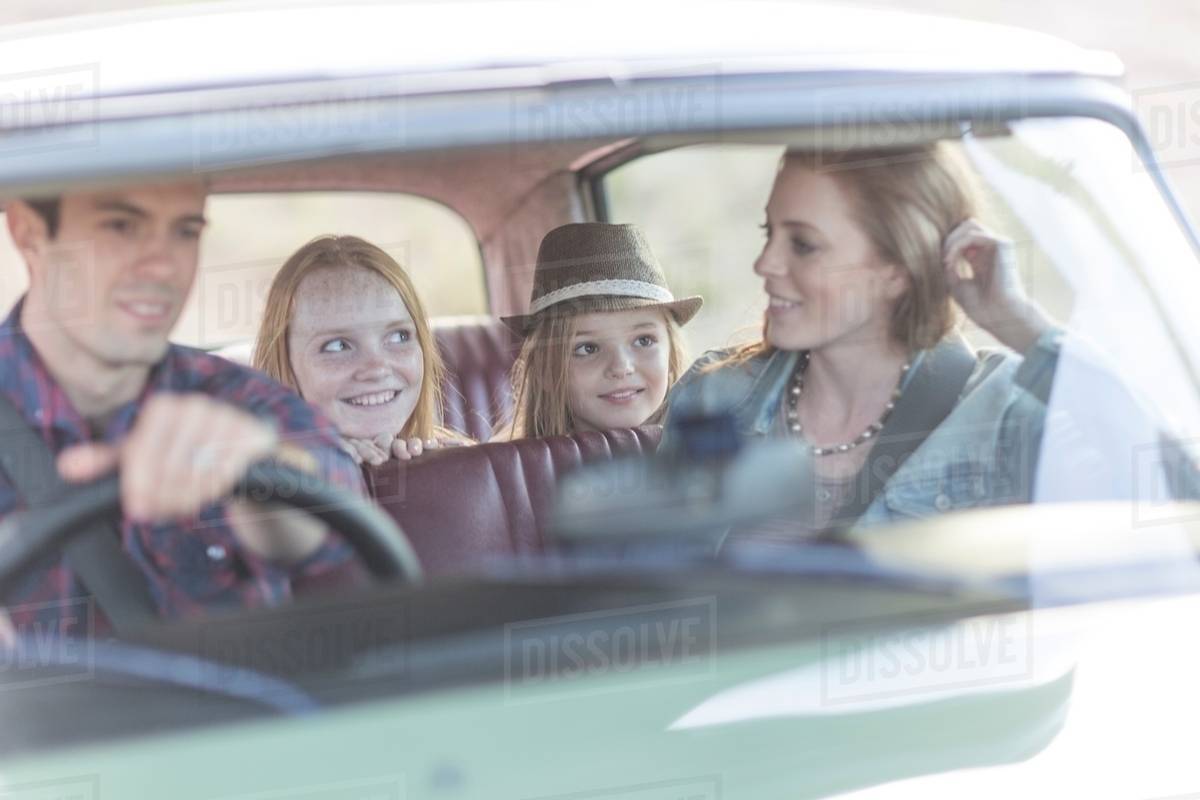 Family in car together, taking road trip - Stock Photo - Dissolve