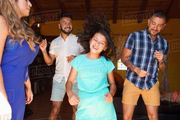 Girl and family dancing in living room - Stock Photo - Dissolve