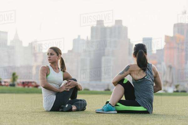 Two friends warming up to exercise together outdoors - Stock Photo ...