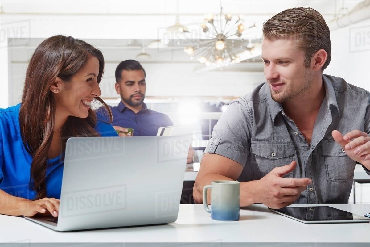 Two business colleagues having discussion at desk - Stock Photo - Dissolve