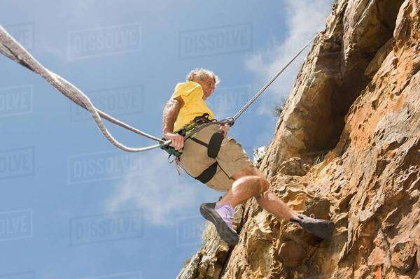 Man abseiling - Stock Photo - Dissolve