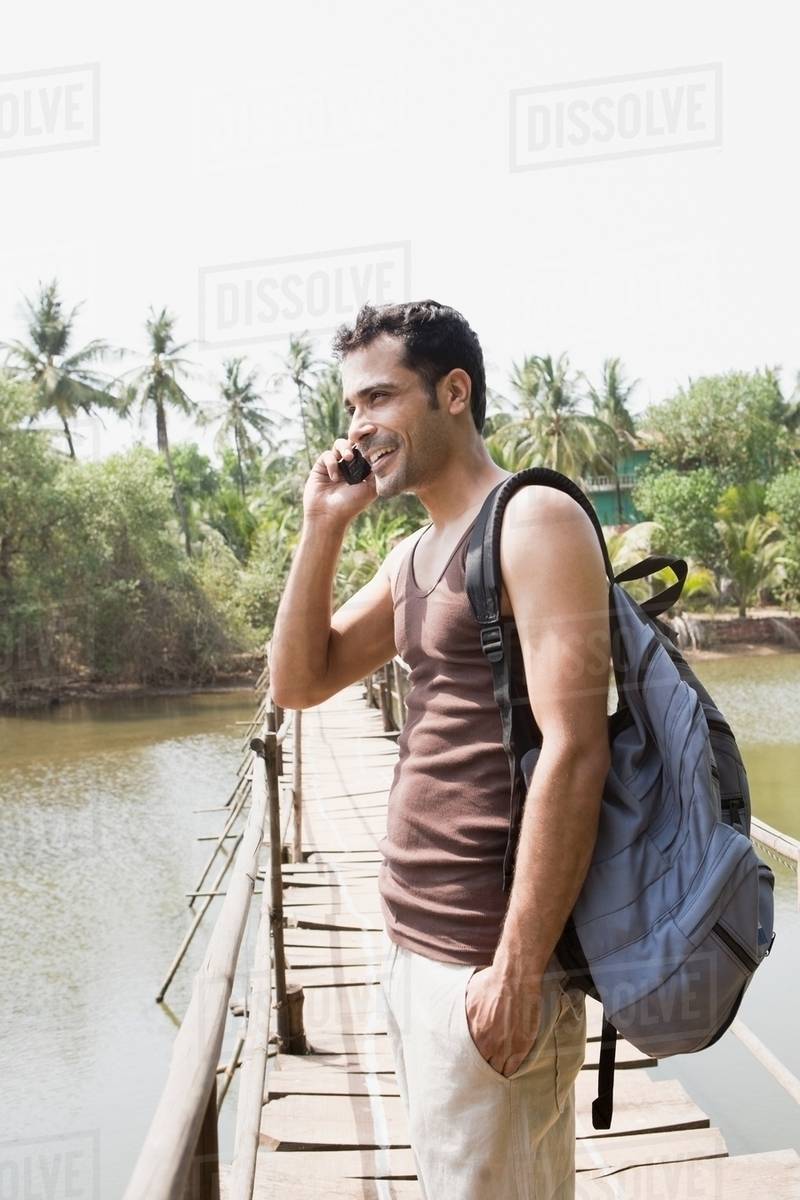 Man on bridge on cellphone - Royalty-free Stock Photo | Dissolve