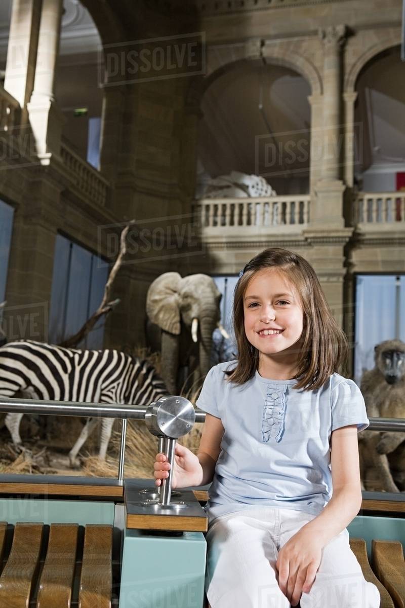 Girl sitting in a museum - Royalty-free Stock Photo | Dissolve