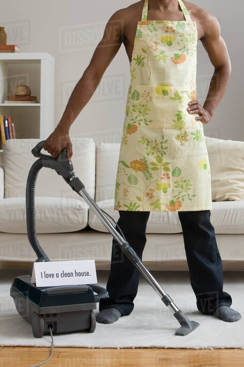 A man vacuum cleaning - Stock Photo - Dissolve
