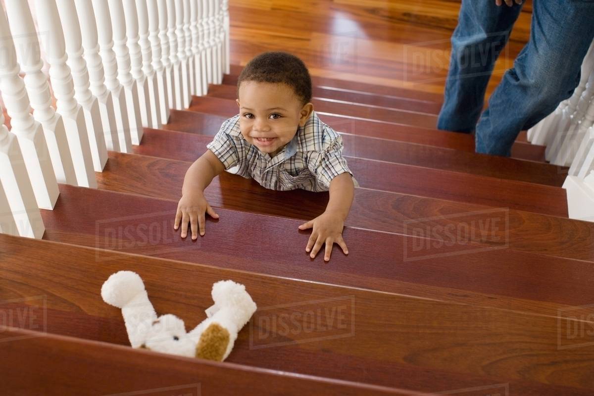 Boy climbing stairs - Stock Photo - Dissolve
