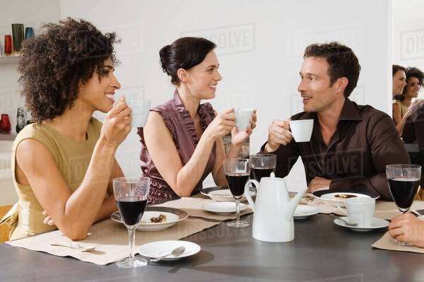 Friends talking over coffee - Royalty-free Stock Photo | Dissolve