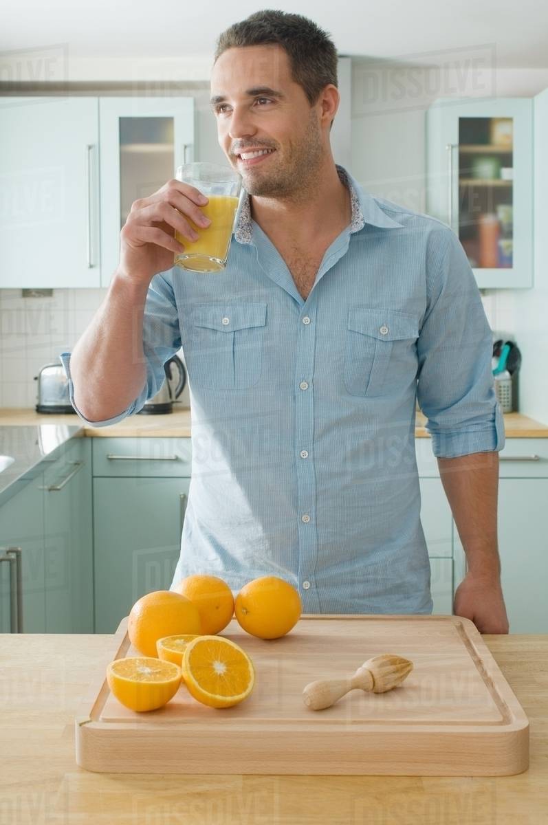 Man drinking orange juice - Stock Photo - Dissolve