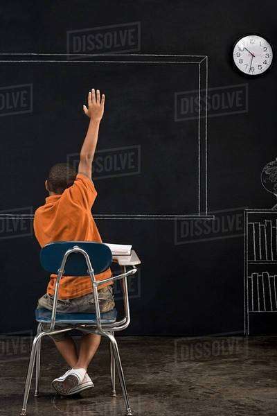 Rear view of a boy with his arm raised - Royalty-free Stock Photo ...