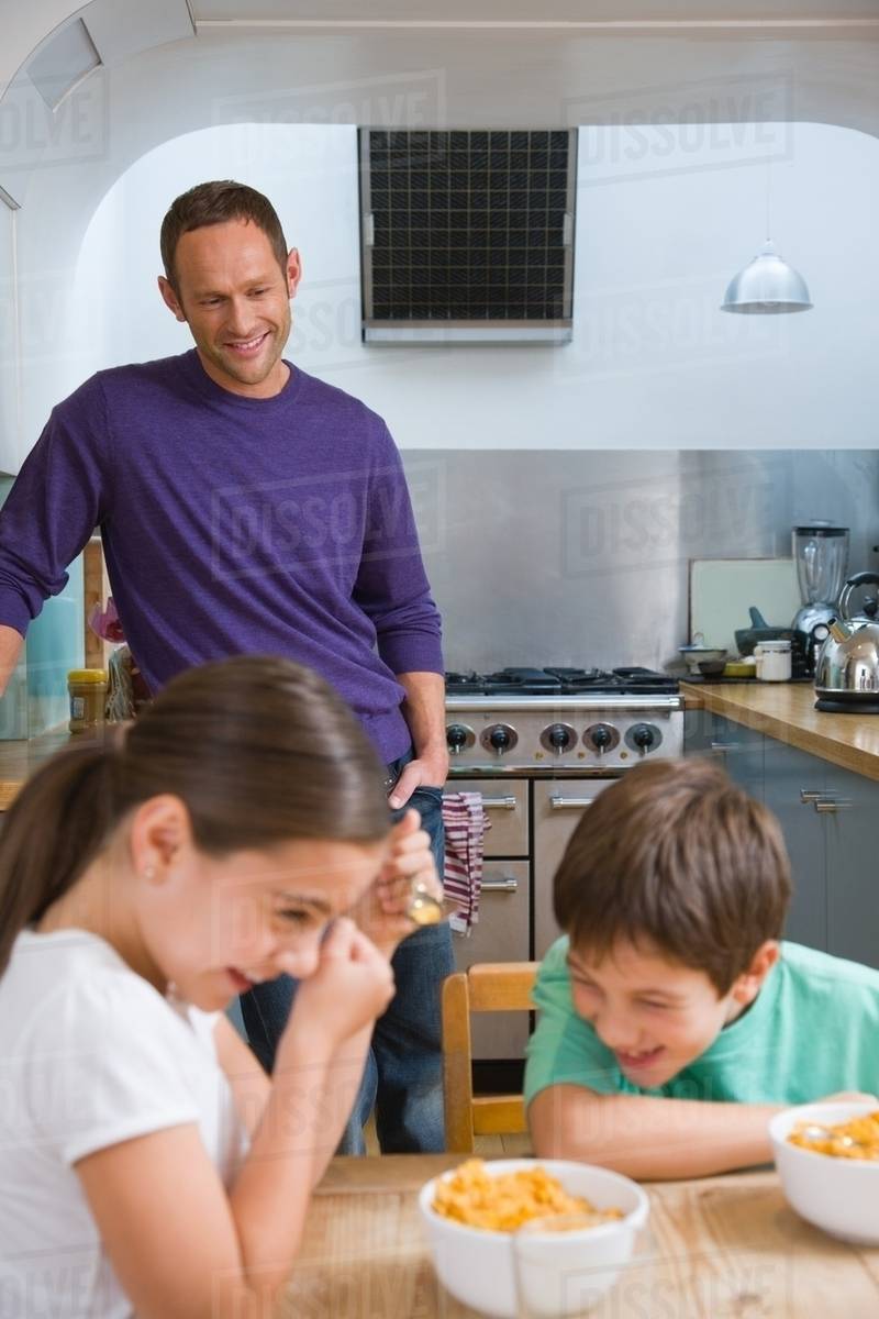 Family laughing at breakfast - Royalty-free Stock Photo | Dissolve