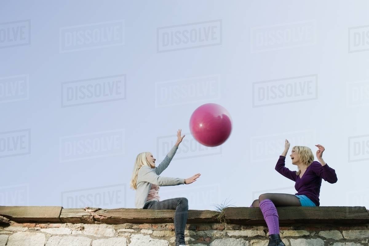 Friends throwing a ball - Royalty-free Stock Photo | Dissolve