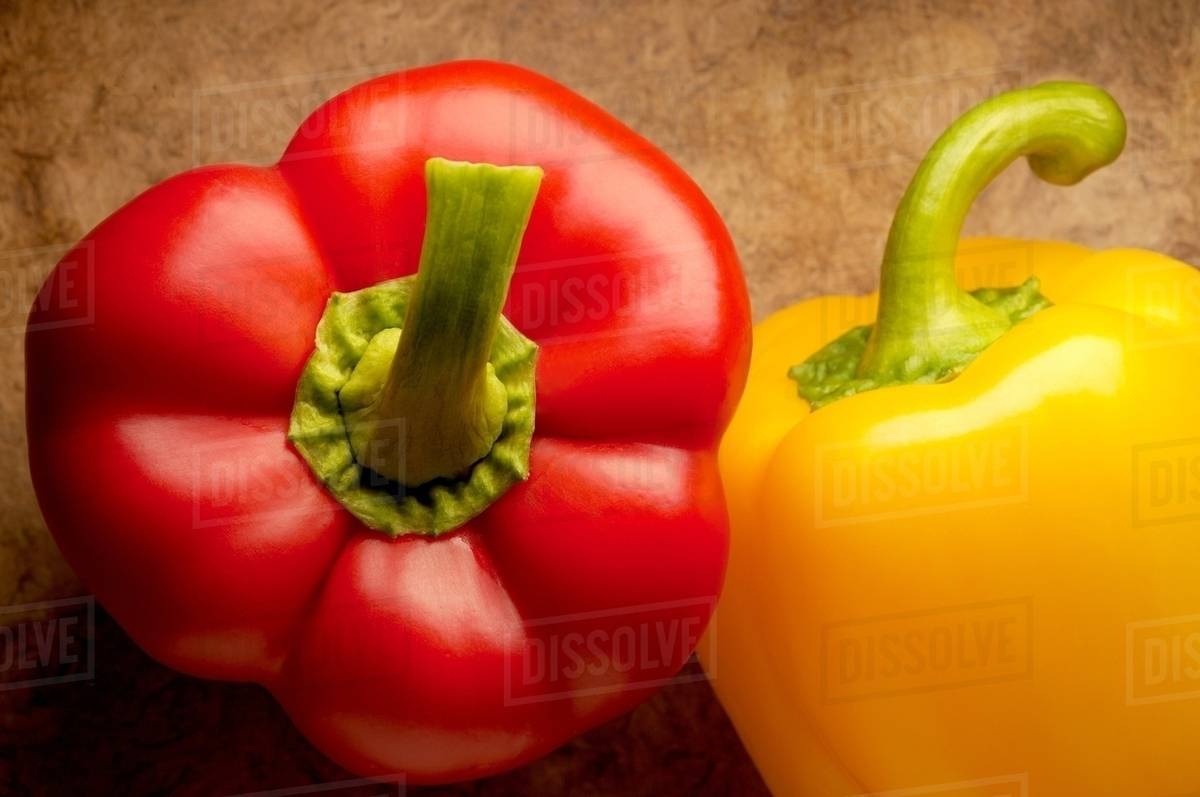 Two peppers on textured background - Stock Photo - Dissolve