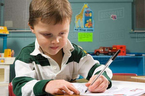 A boy writing - Royalty-free Stock Photo | Dissolve
